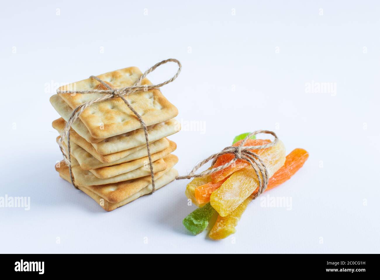 Biscuits and candied fruit tied with twine isolated on a white ...