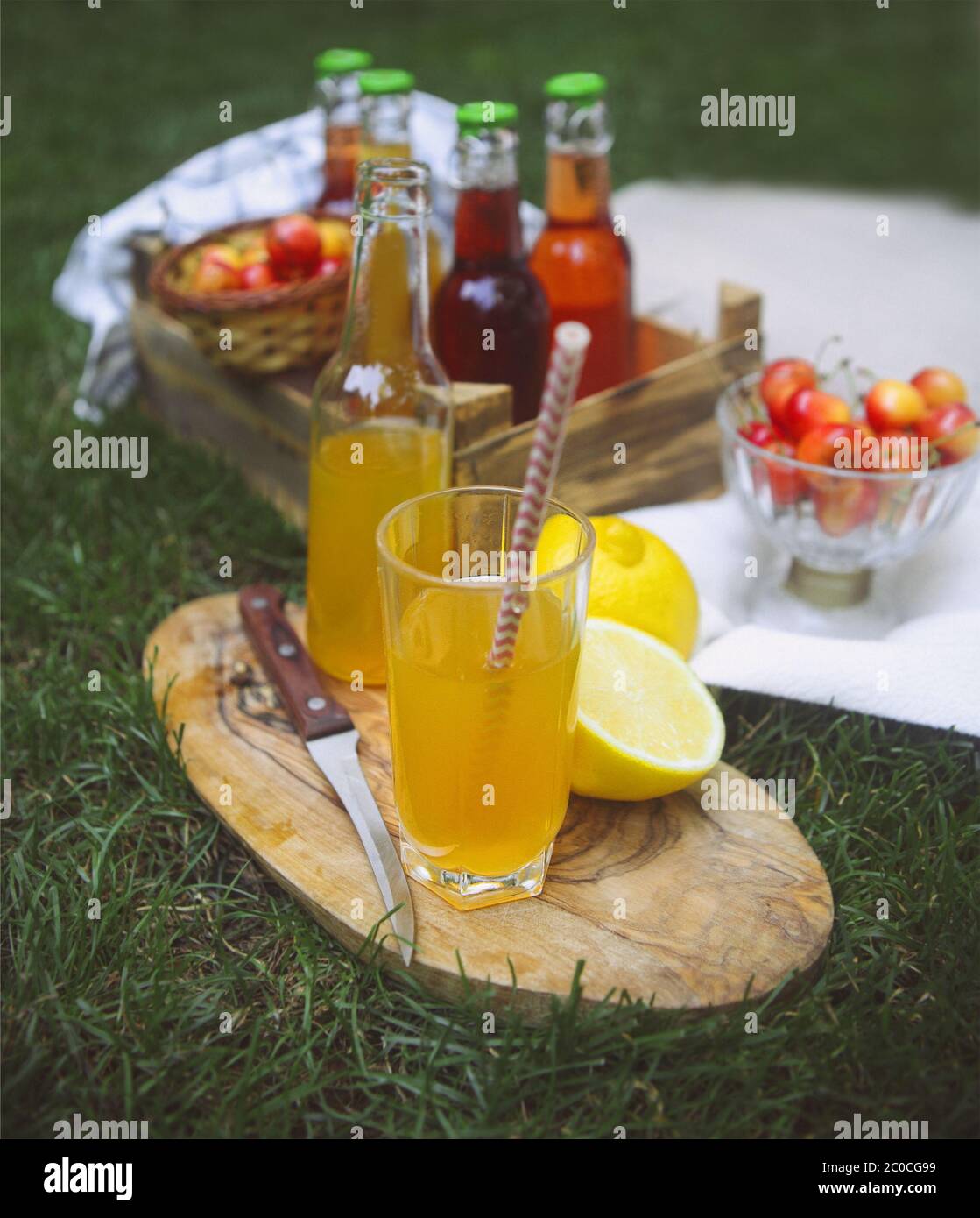 Lemonade with cherry, pear and lemon on the garden picnic Stock Photo ...