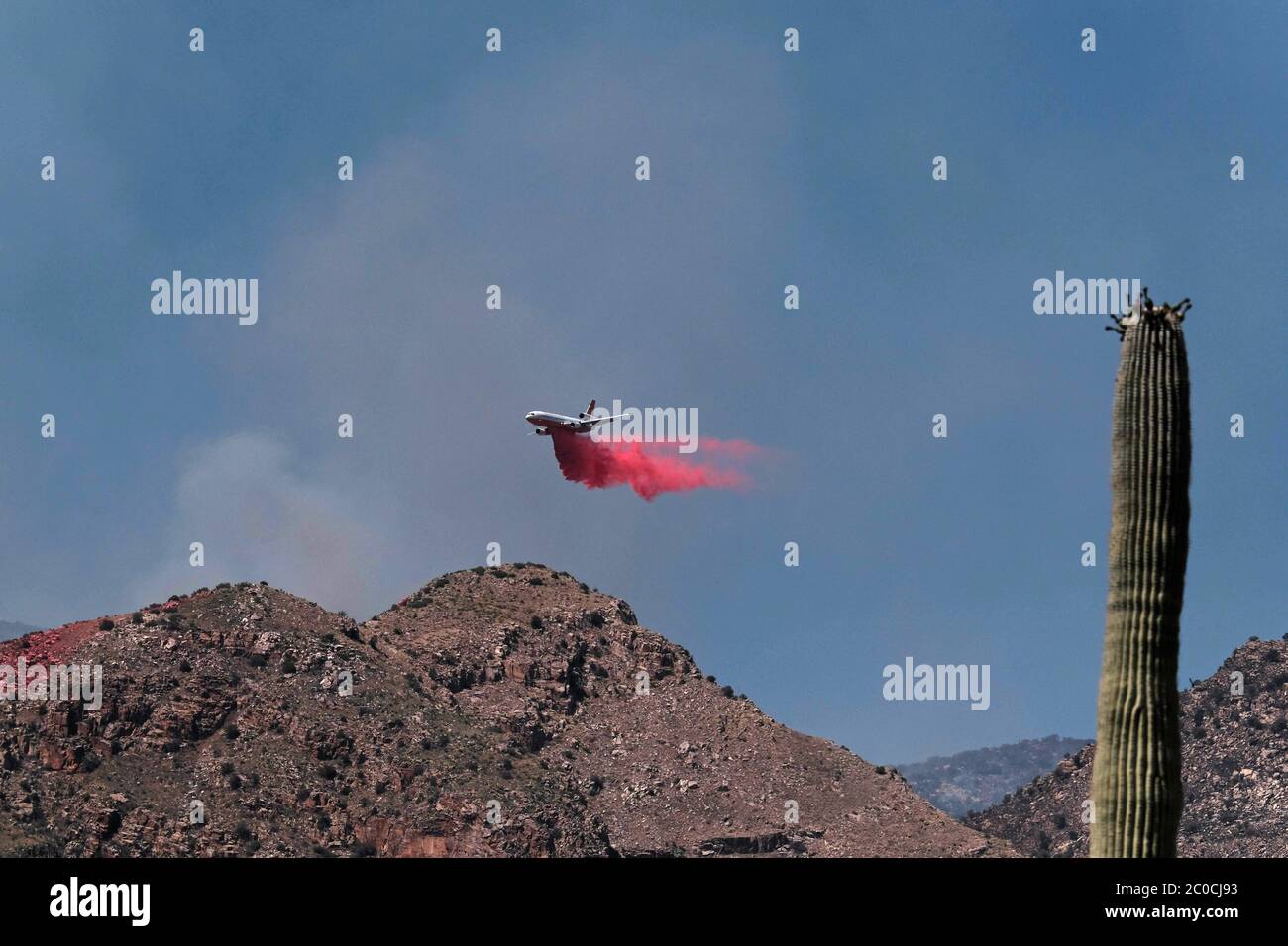Tucson, Arizona, USA. 11th June, 2020. Firefighters spray fire ...