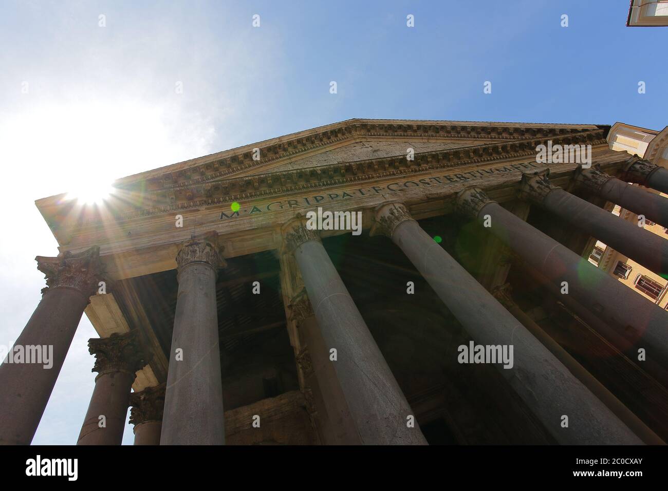 Entrance to Pantheon in Rome, with sun shining through the roof edge ...
