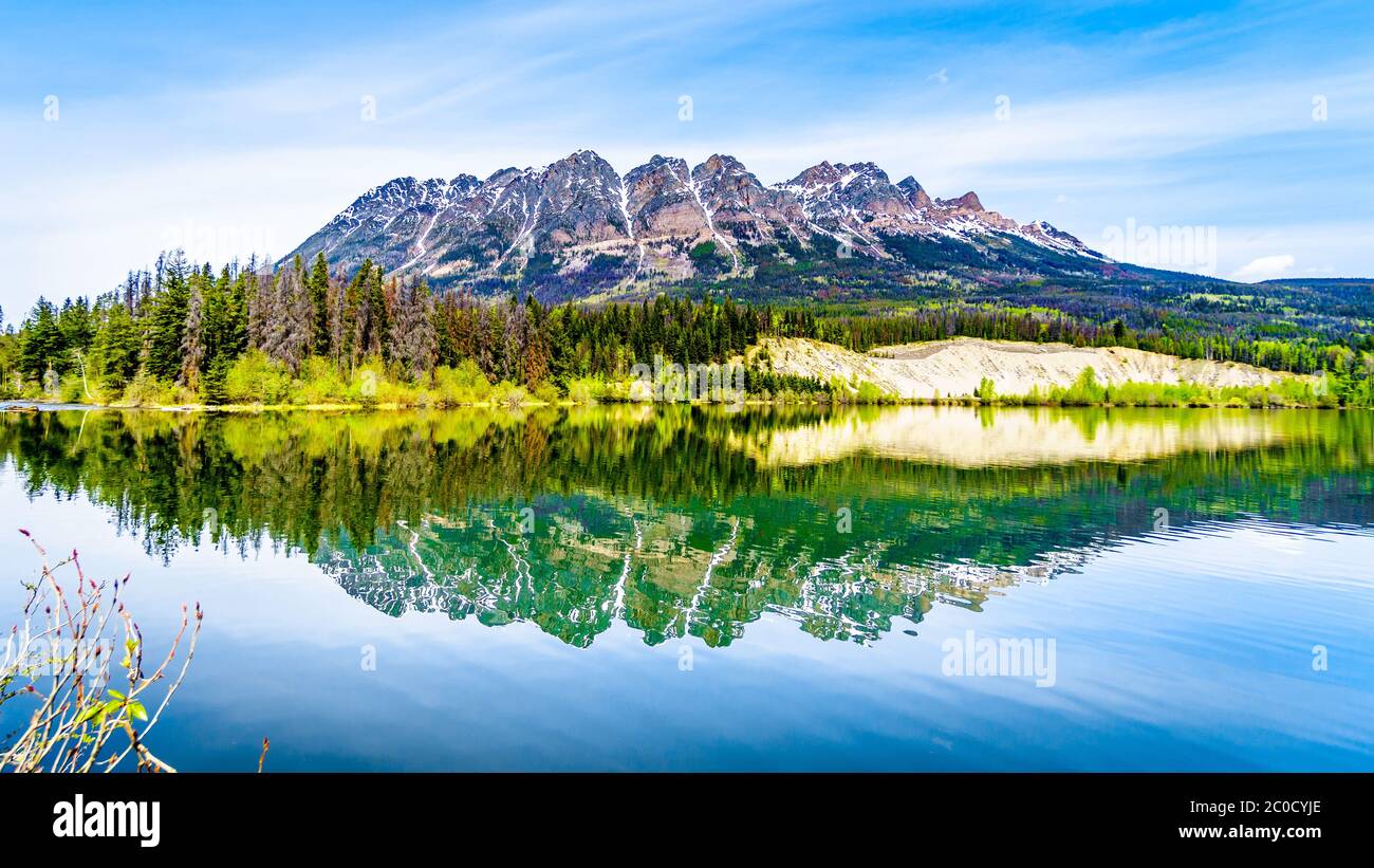 Reflection of Yellowhead Mountain on the smooth water surface of ...