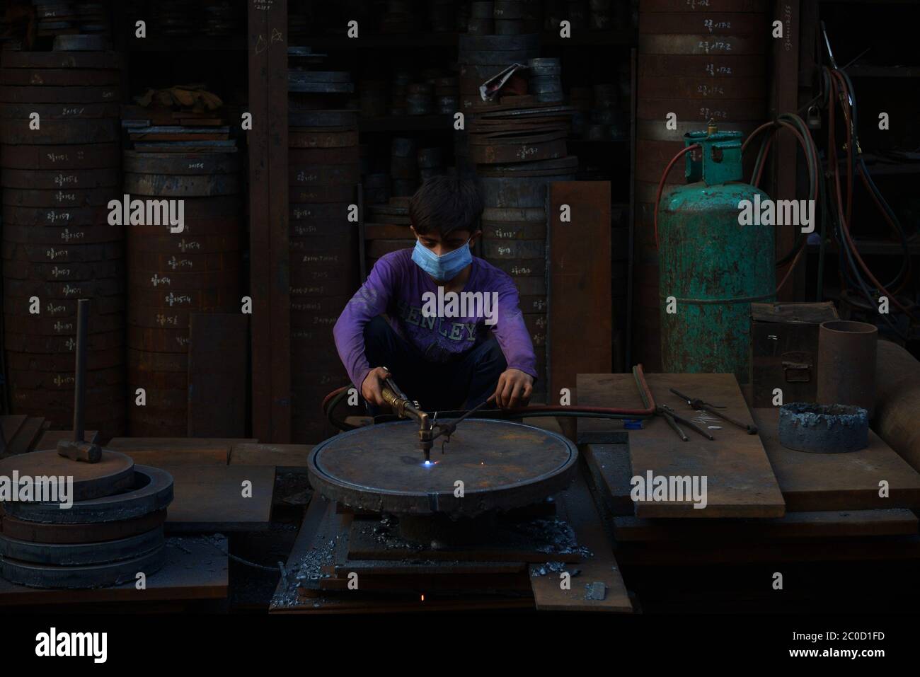 Pakistani young laborer busy in their workplace at iron market to earn ...
