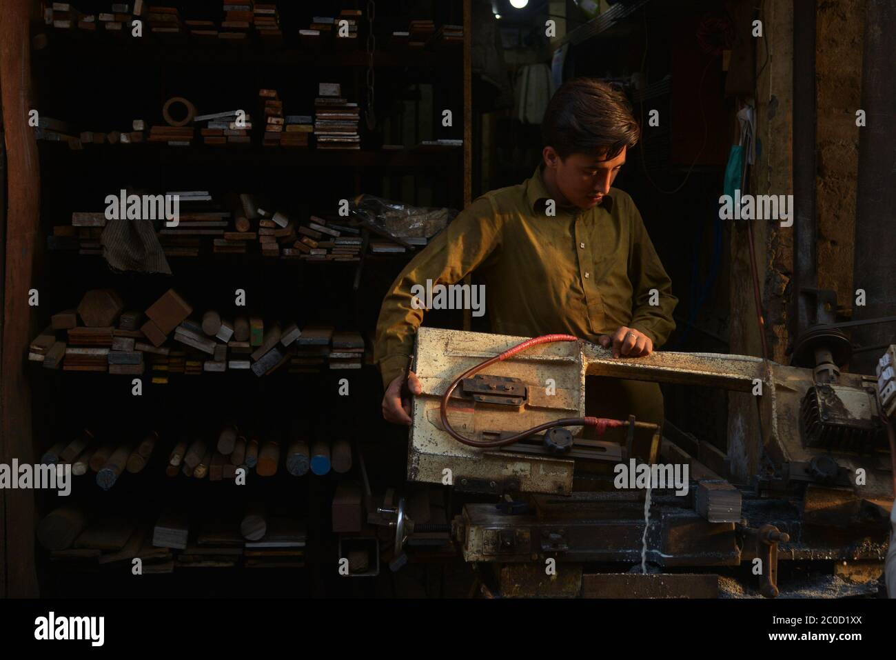 Pakistani young laborer busy in their workplace at iron market to earn ...