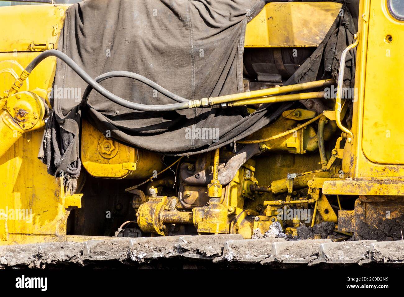 the engine compartment of the caterpillar tractor is covered with an ...