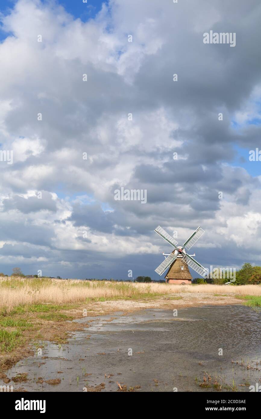 Dutch windmill bu river over beautiful sky Stock Photo - Alamy