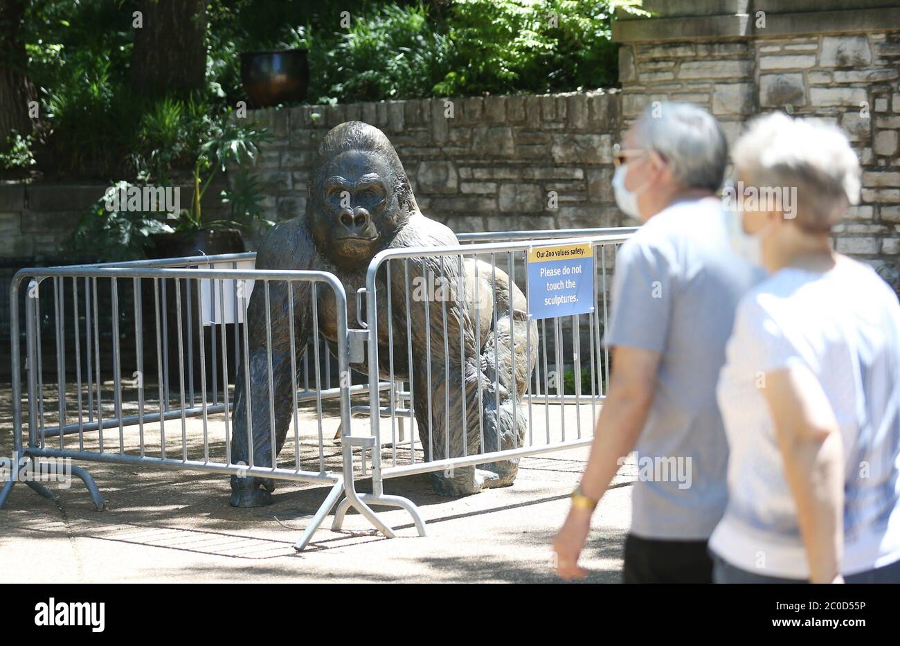 St. Louis, United States. 11th June, 2020. People walk past the statue ...