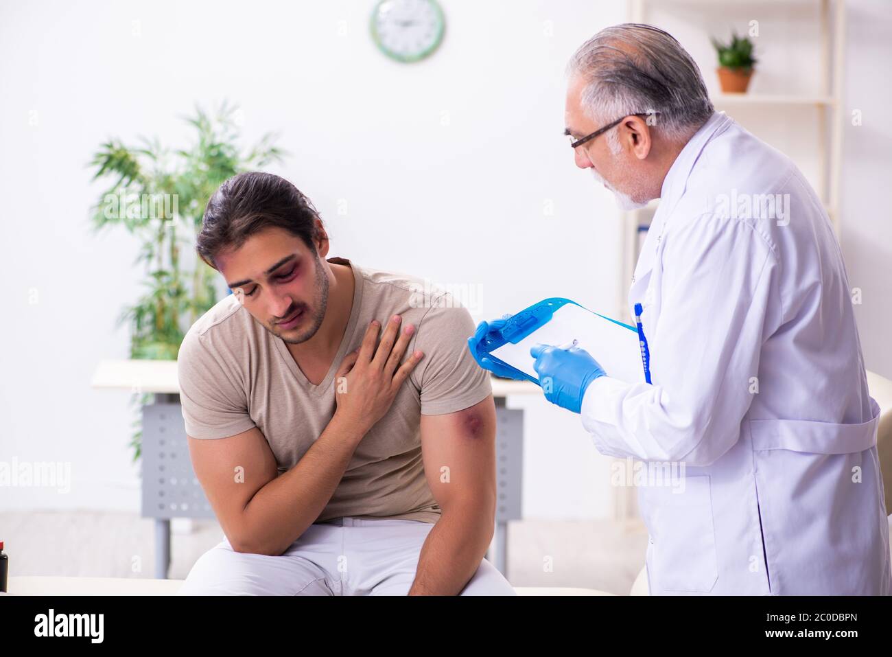 Young face injured man visiting experienced male doctor traumatologist ...