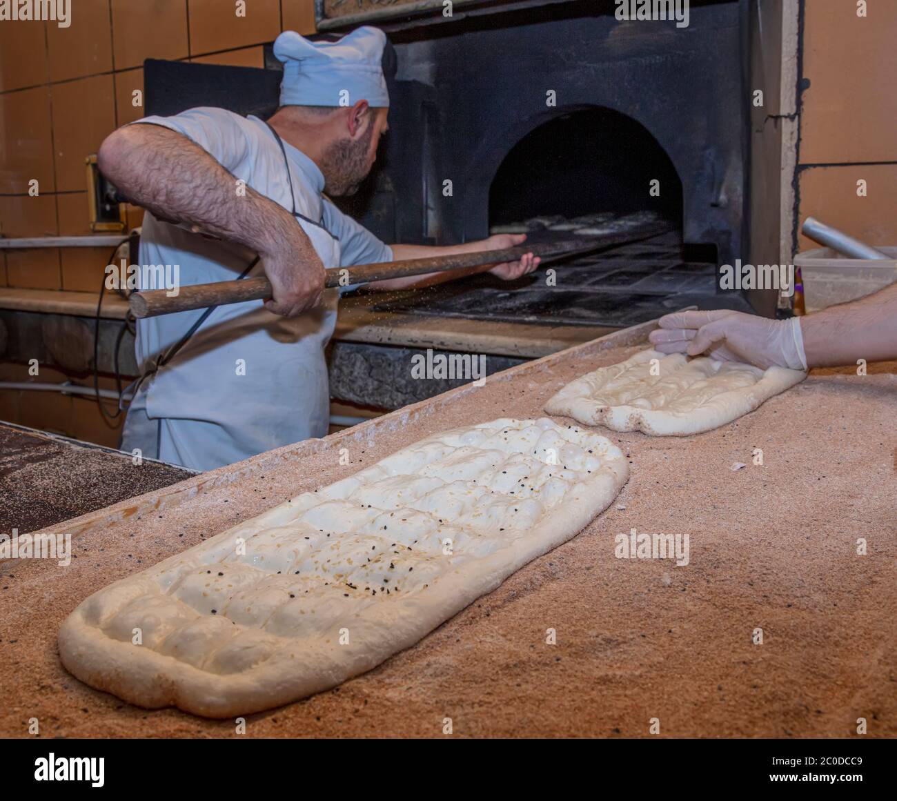 A baker making Turkish pita bread. Bakery,Turkish pita bread making ...