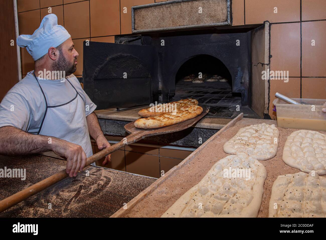 A baker making Turkish pita bread. Bakery,Turkish pita bread making ...