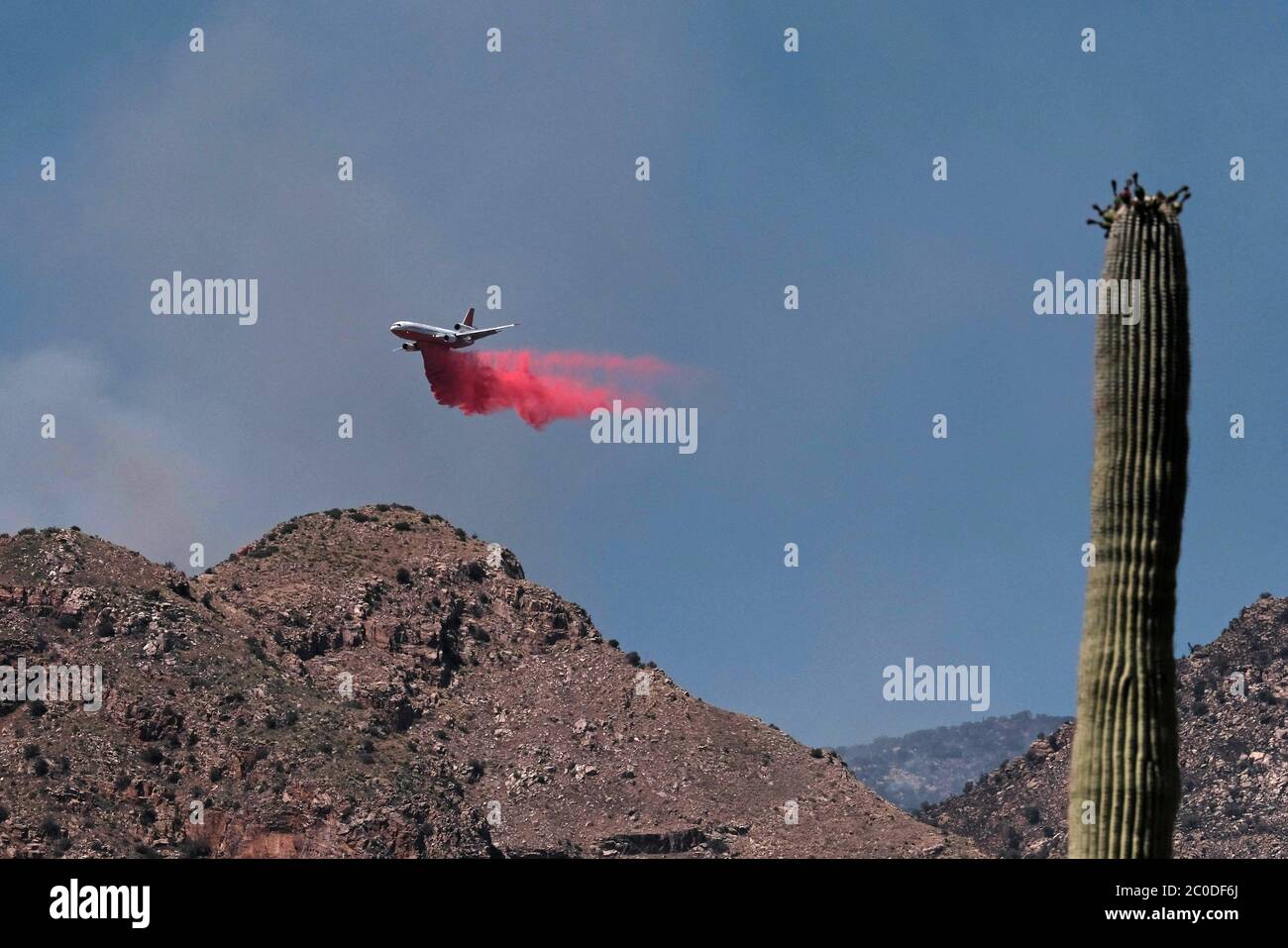 Tucson, Arizona, USA. 11th June, 2020. Firefighters spray fire ...