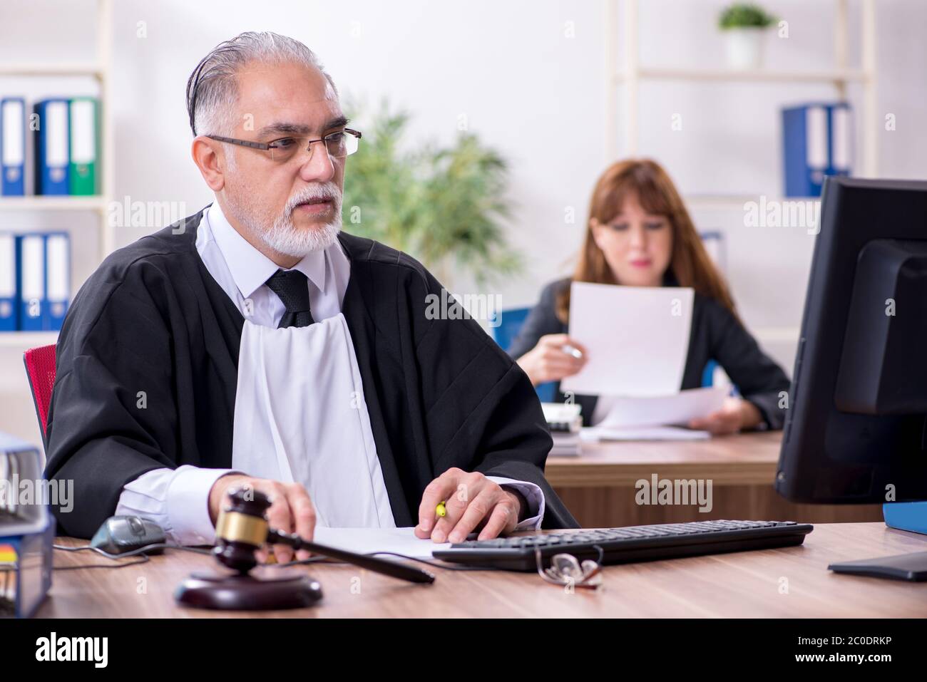 Old judge and his young secretary in the office Stock Photo - Alamy
