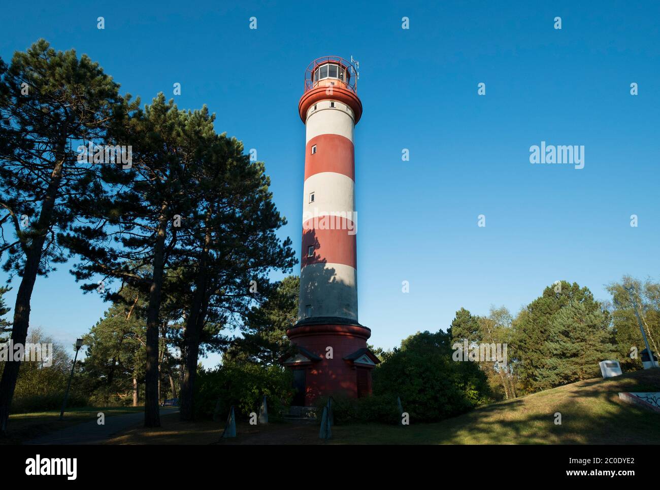 The iconic, white and red striped old lighthouse near Nida on the ...