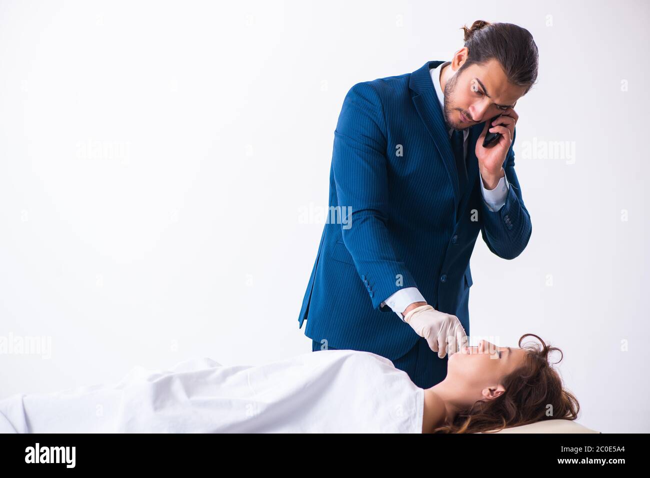 Police coroner examining dead body in morgue Stock Photo - Alamy