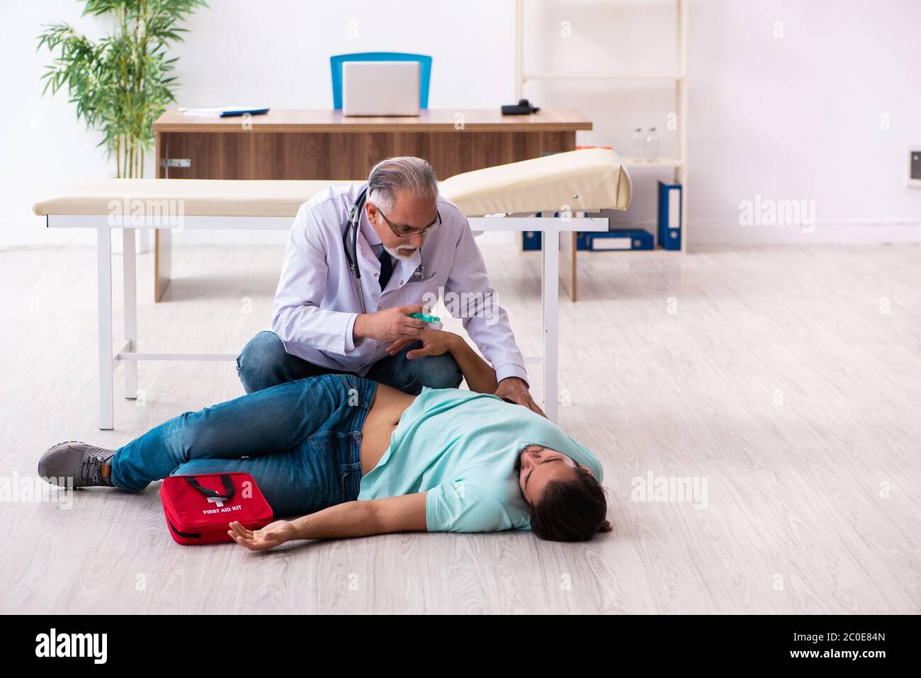 Experienced doctor and male patient in first aid concept Stock Photo ...