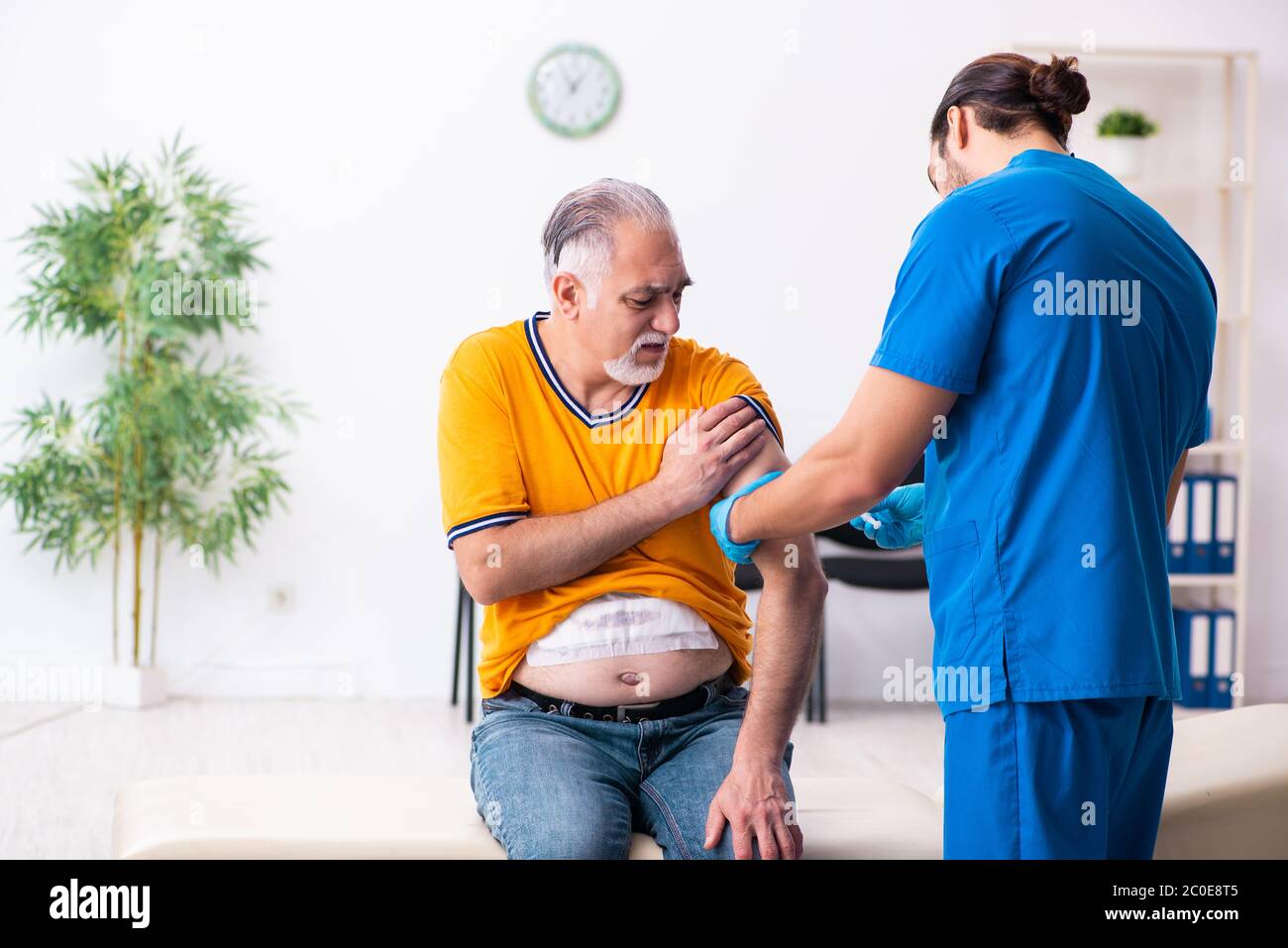 Old man visiting male doctor Stock Photo - Alamy