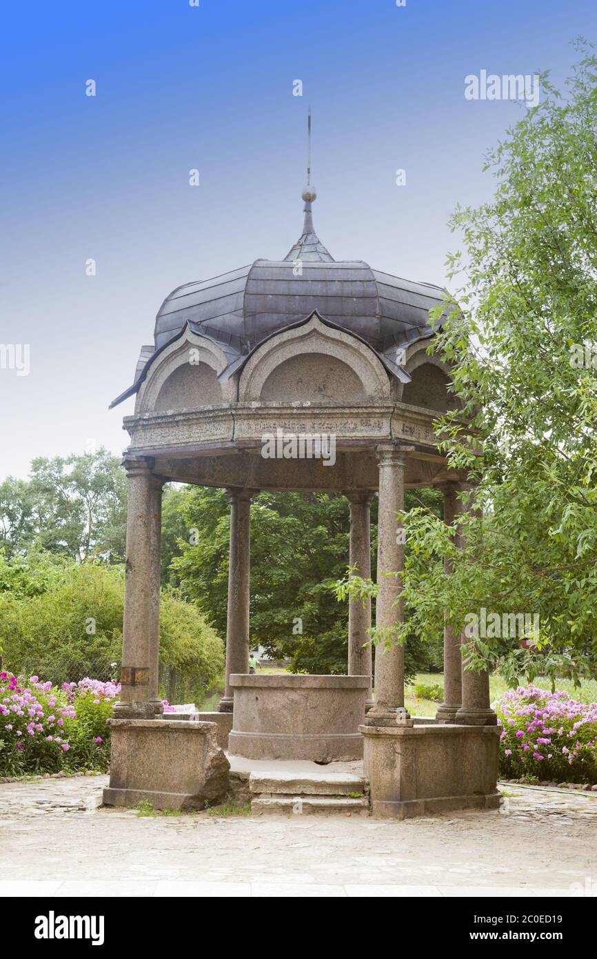 Stone arbor with a bowl with sacred source in the Stock Photo - Alamy