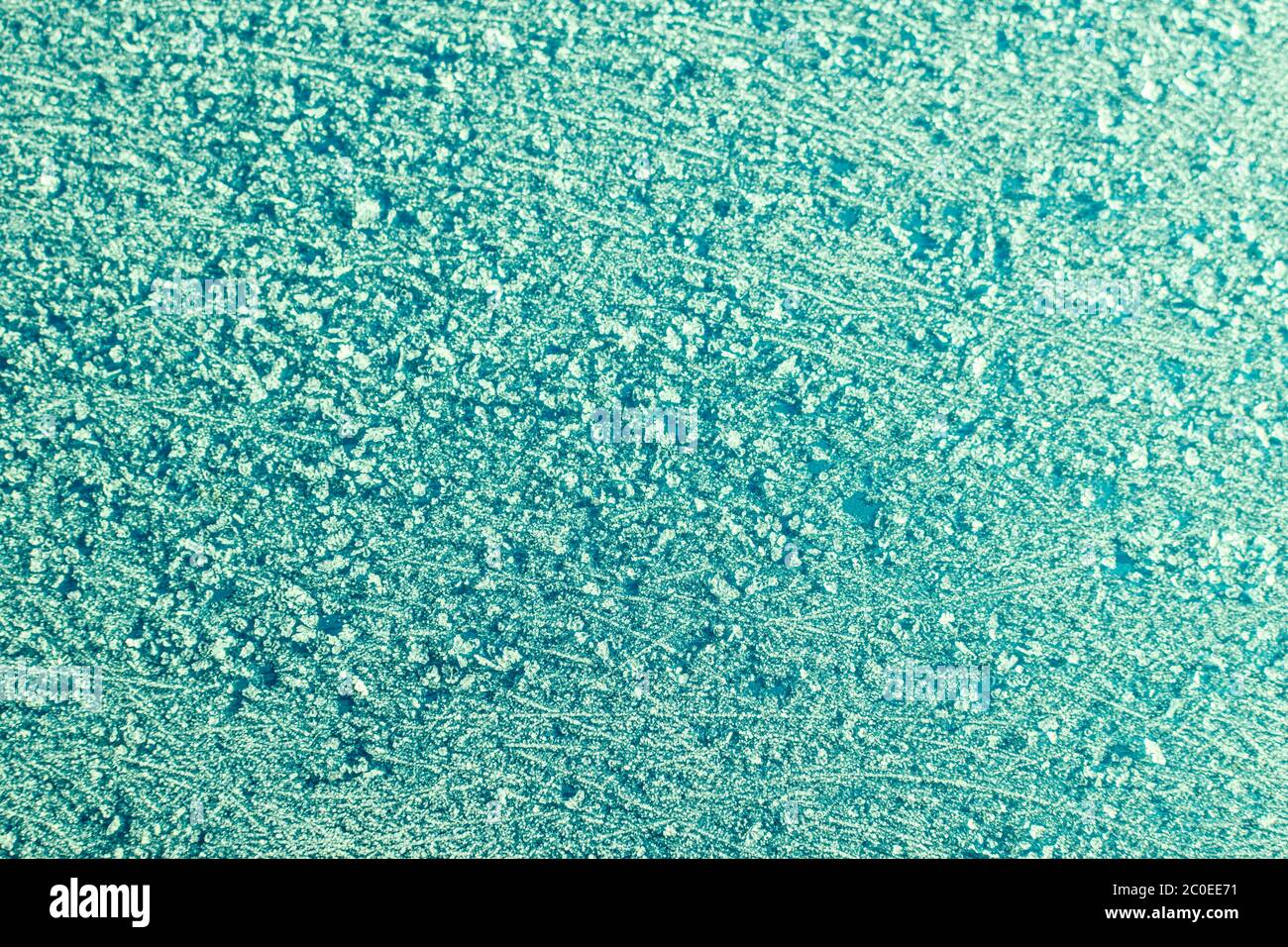 Texture of sparkling first cold ice. Snowy backdrop in green colors ...