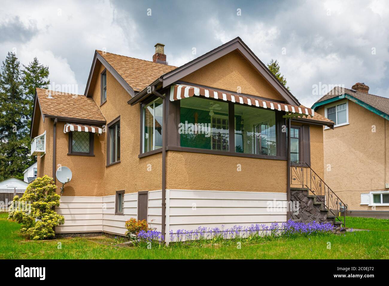 Modest family house with green lawn in front. Old residential house ...