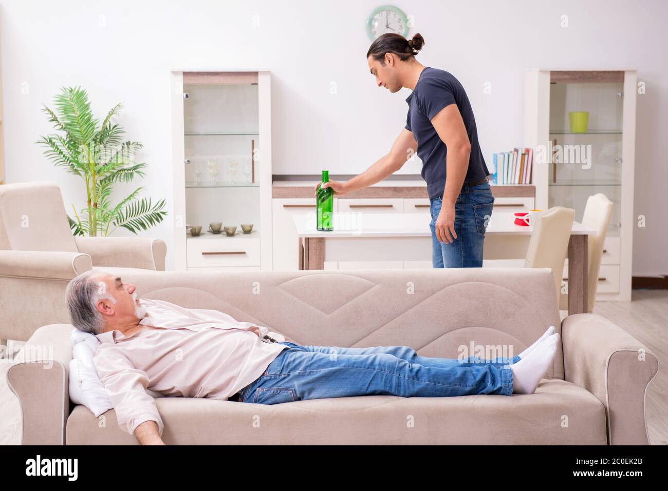 Drinking problems in the family between son and father Stock Photo - Alamy