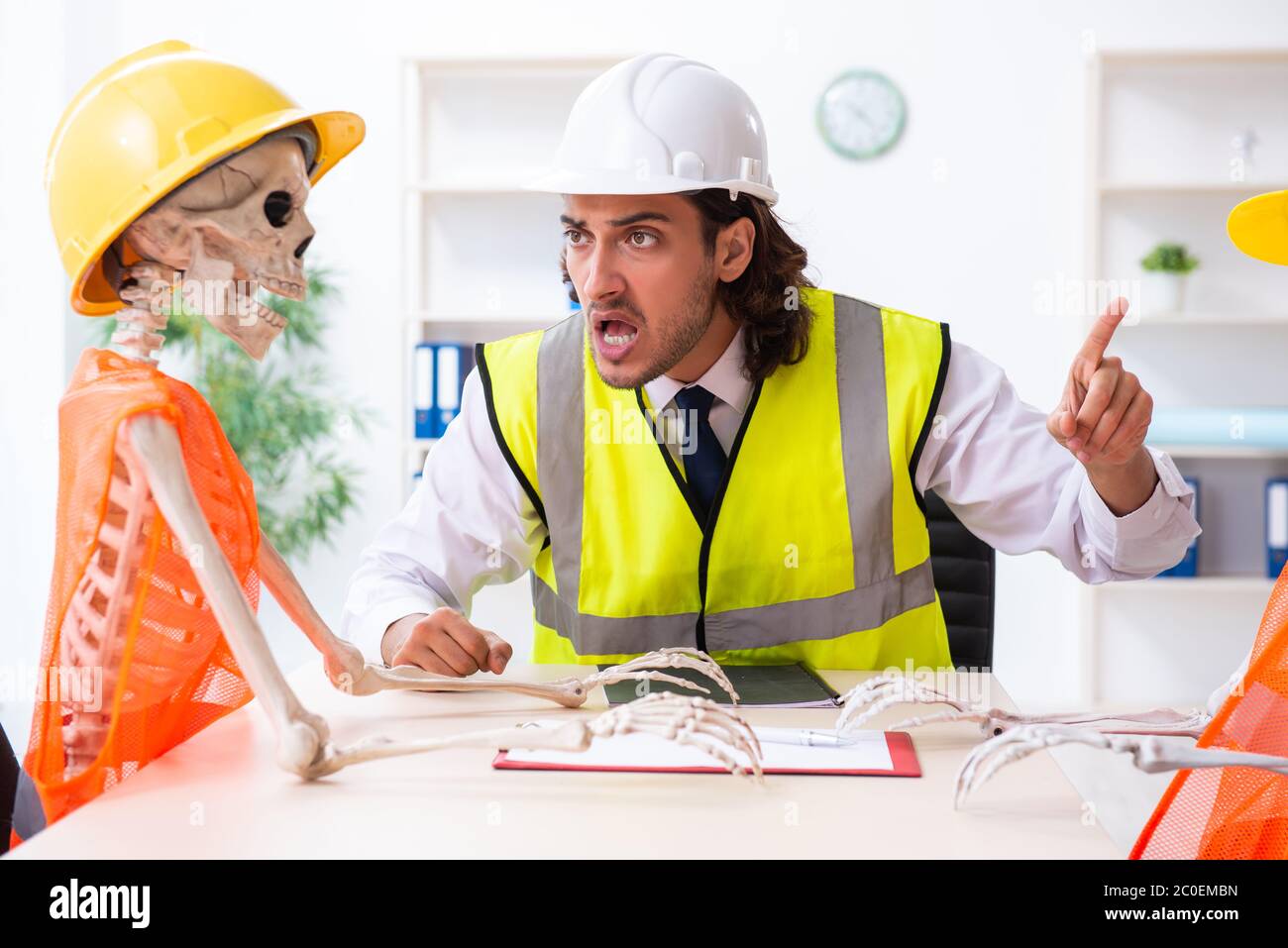 Funny construction meeting with boss and skeletons Stock Photo - Alamy