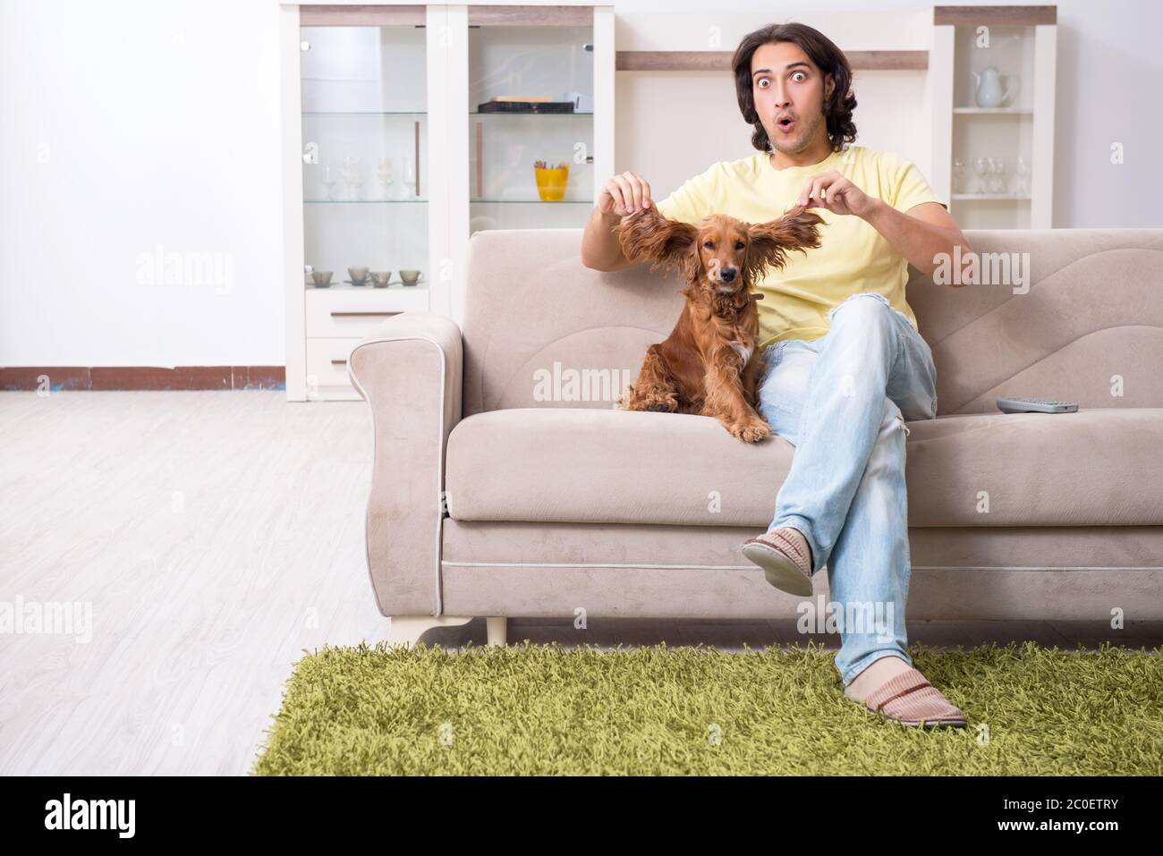 Young man with cocker spaniel Stock Photo - Alamy