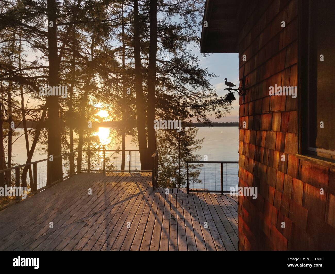 Sunset view from a cabin deck overlooking a lake Stock Photo - Alamy