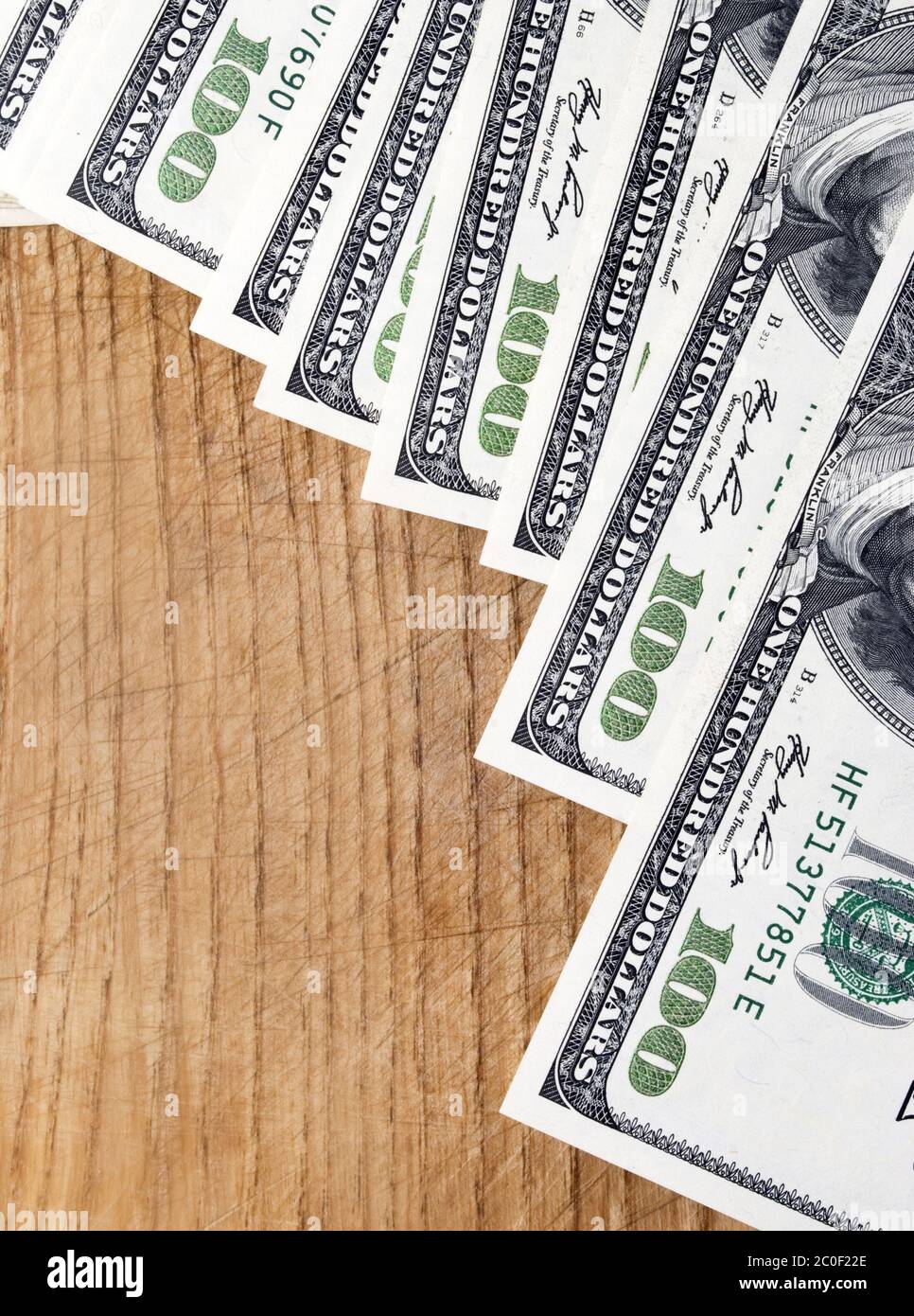 dollars on wood Stock Photo - Alamy