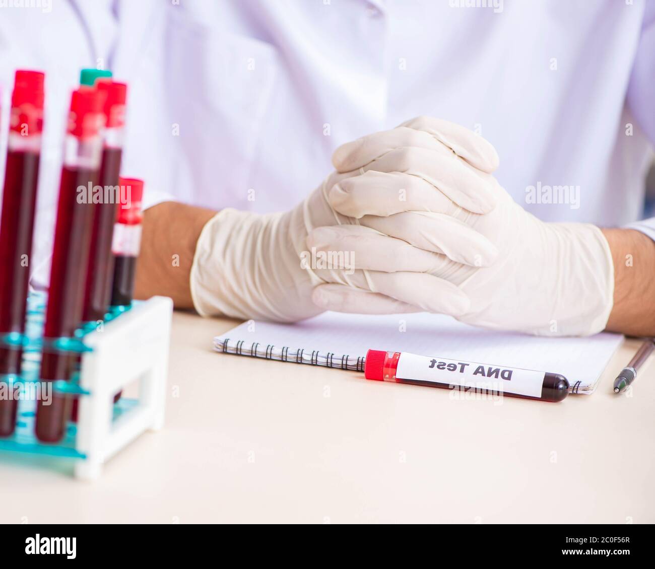 The young handsome lab assistant testing blood samples in hospital ...
