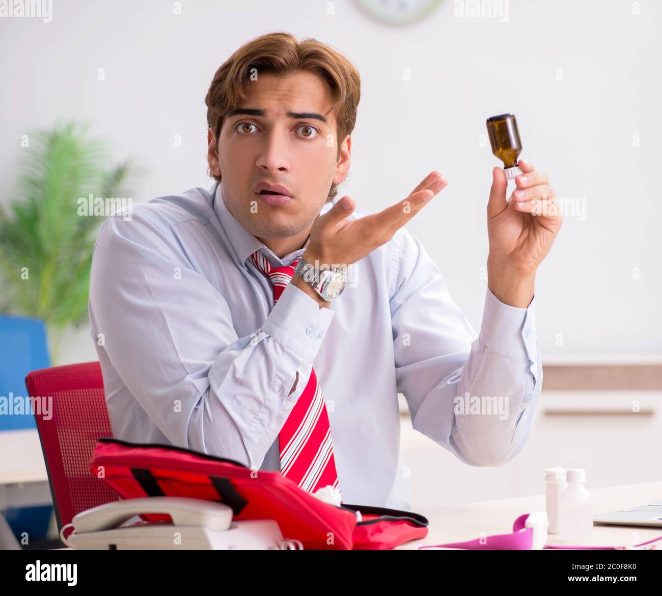 The man with first aid kit in the office Stock Photo - Alamy