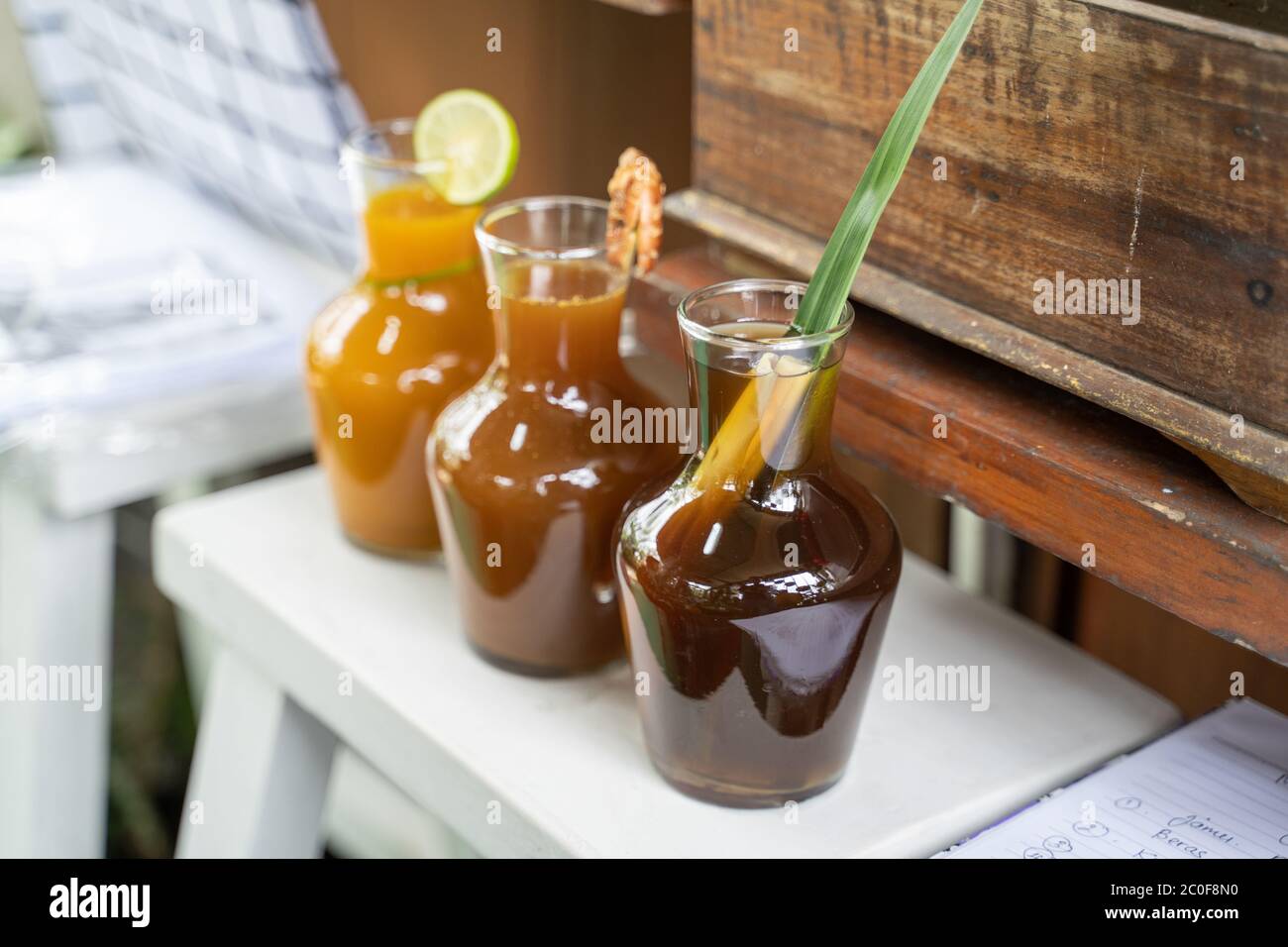 variety of traditional Javanese herbal drinks are packaged in glass ...