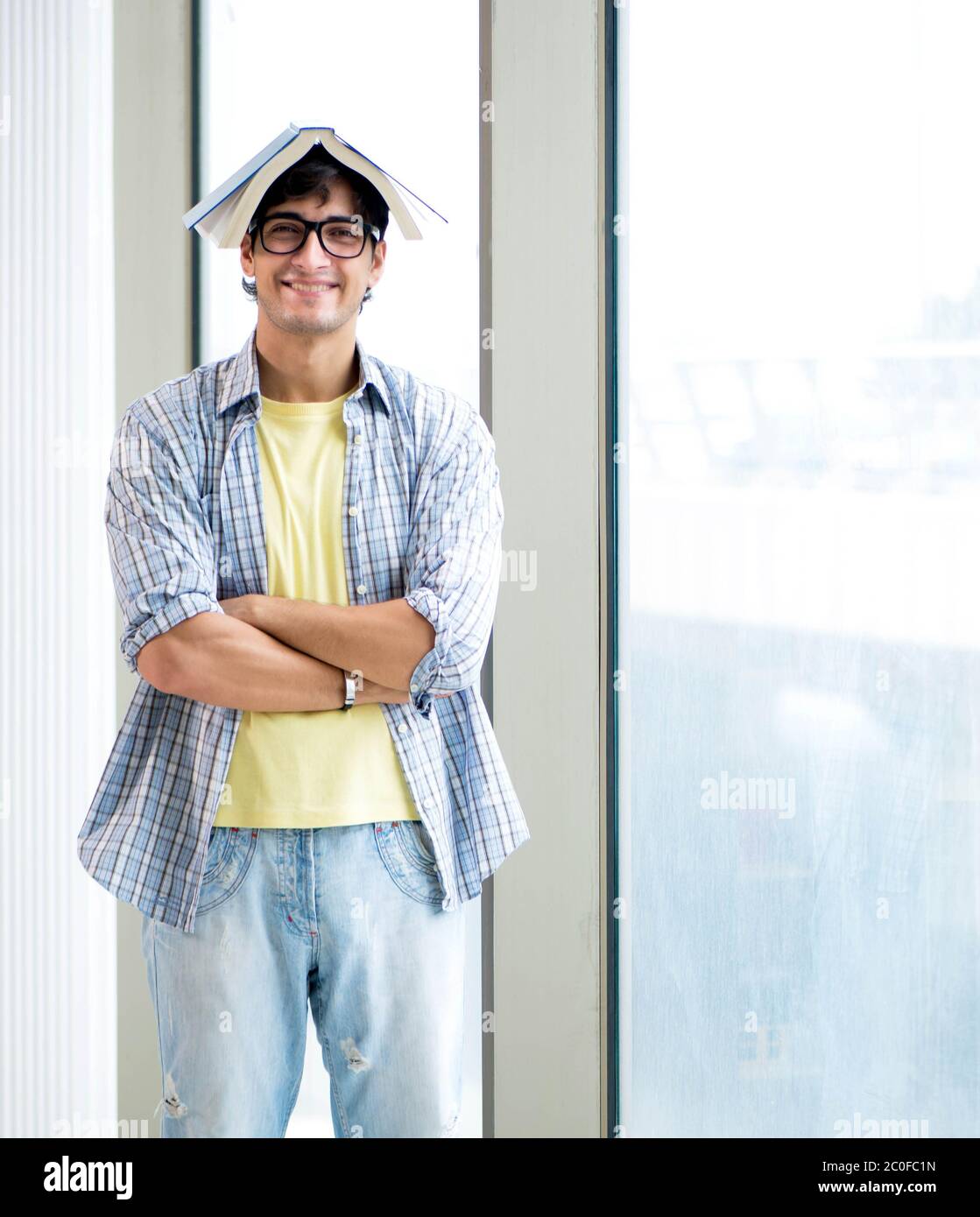 The young handsome student standing at the window Stock Photo - Alamy