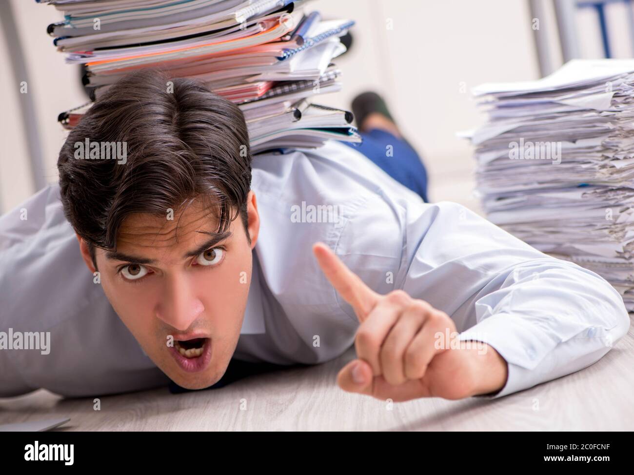 The extremely busy employee working in the office Stock Photo - Alamy