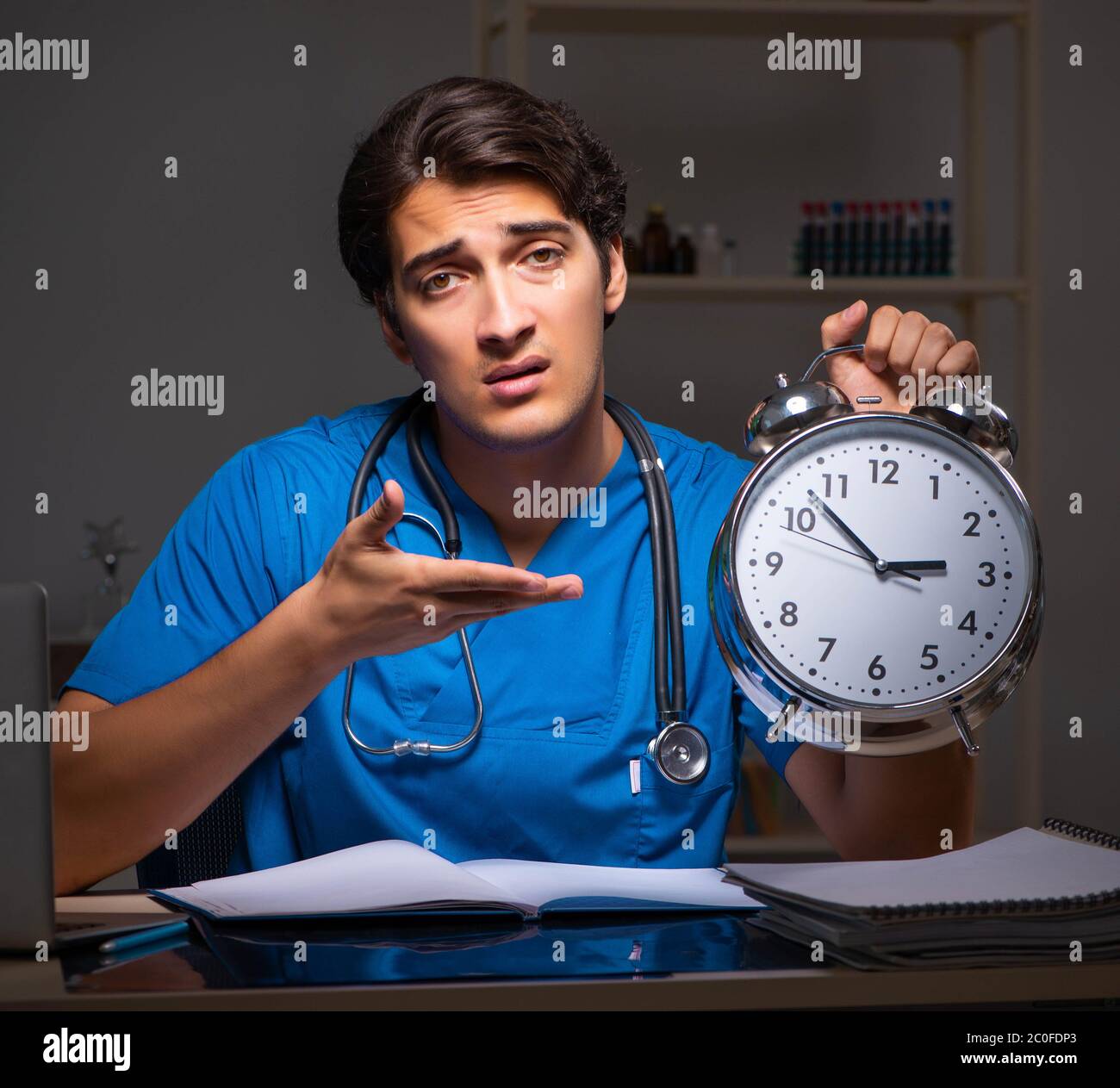 The young handsome doctor working night shift in hospital Stock Photo ...