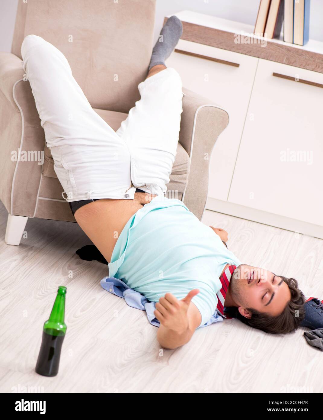 The young drunk handsome man after party at home Stock Photo - Alamy