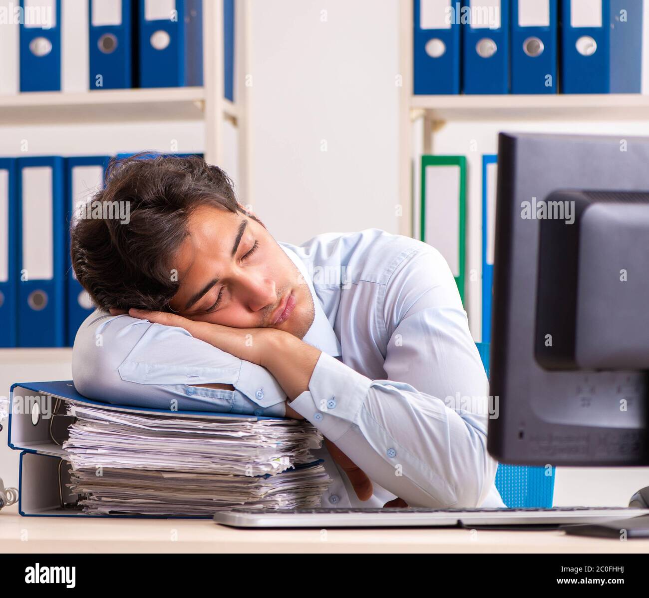 The overloaded busy employee with too much work and paperwork Stock ...
