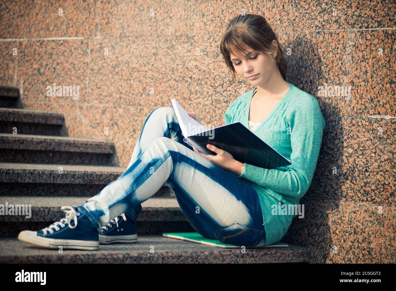 Girl sitting on stairs hi-res stock photography and images - Alamy