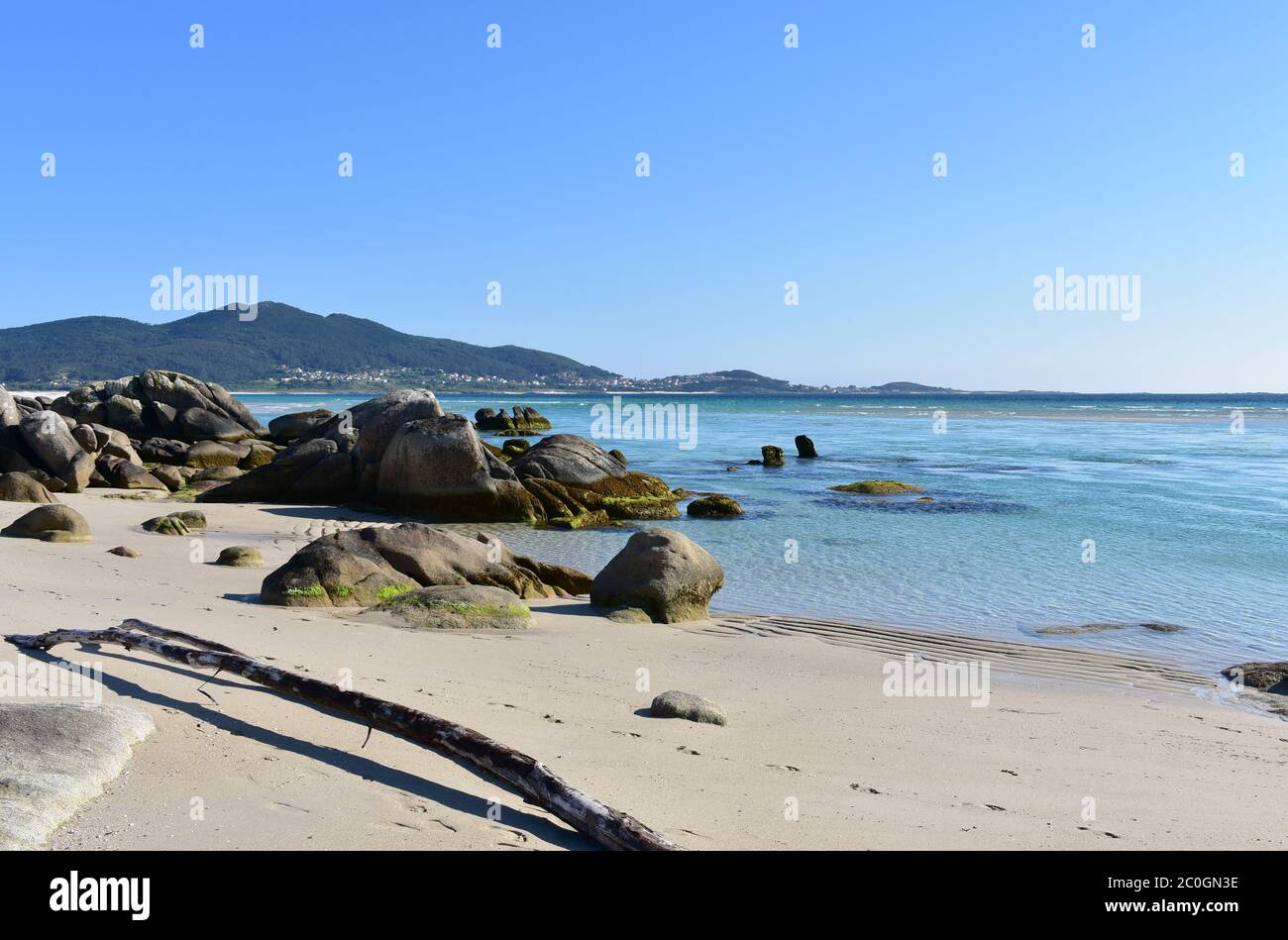 Beach with rocks and transparent water with turquoise colour and blue ...