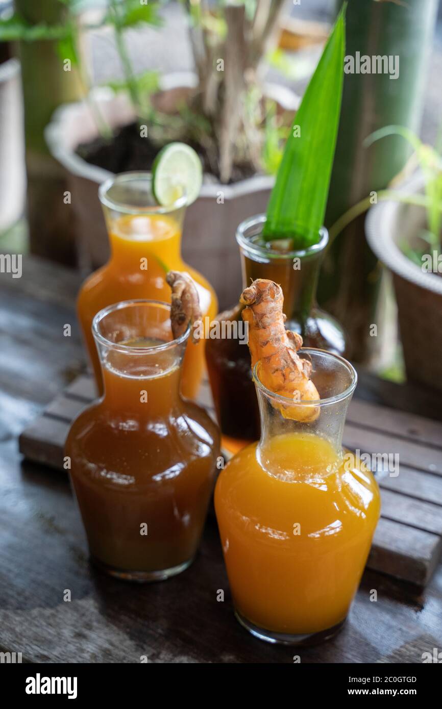 variety of traditional Javanese herbal drinks are packaged in glass ...