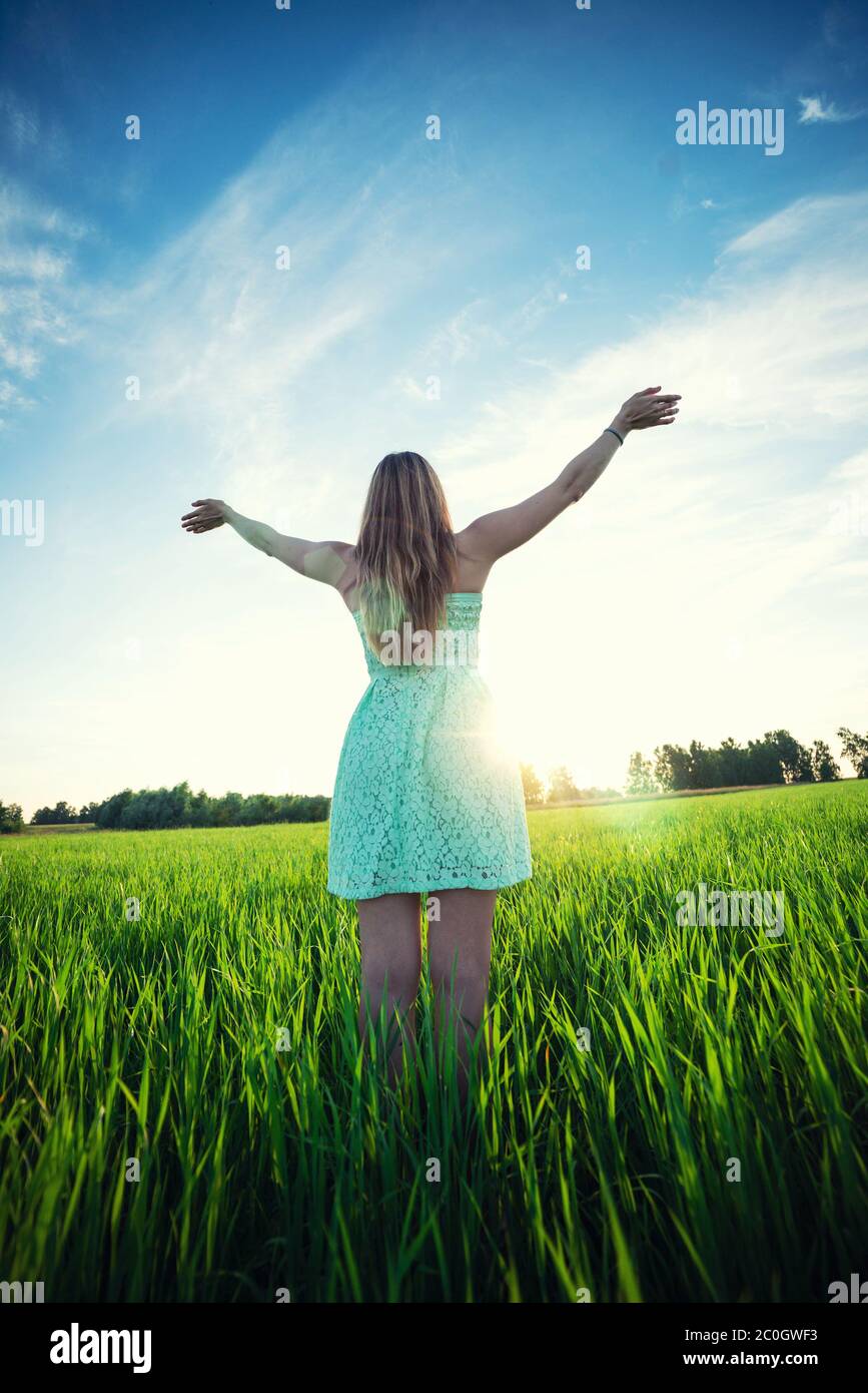 Happiness woman stay outdoor under sunlight of sunset Stock Photo - Alamy