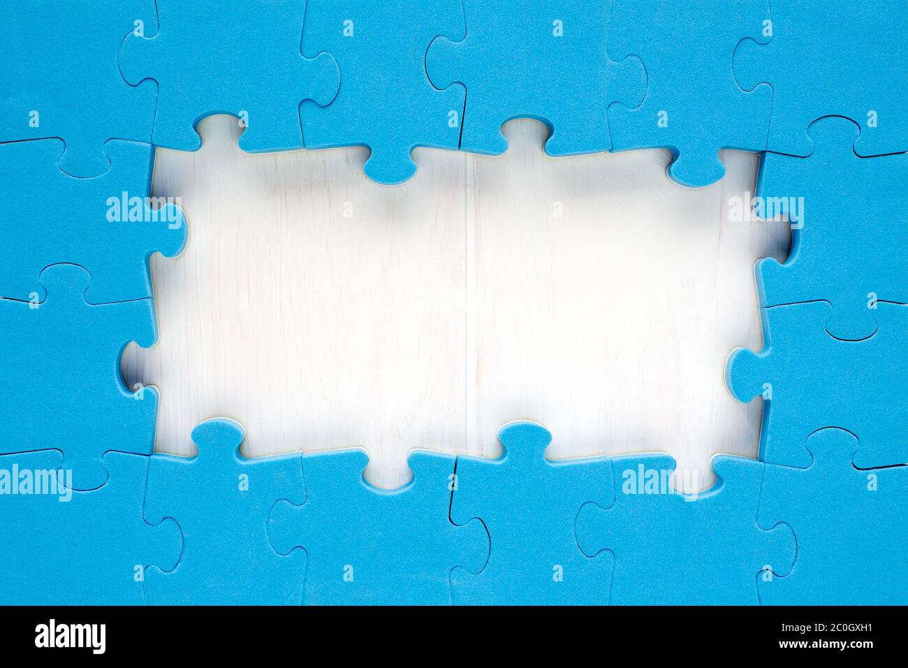Blue jigsaw puzzle pieces arranged as a border Stock Photo - Alamy