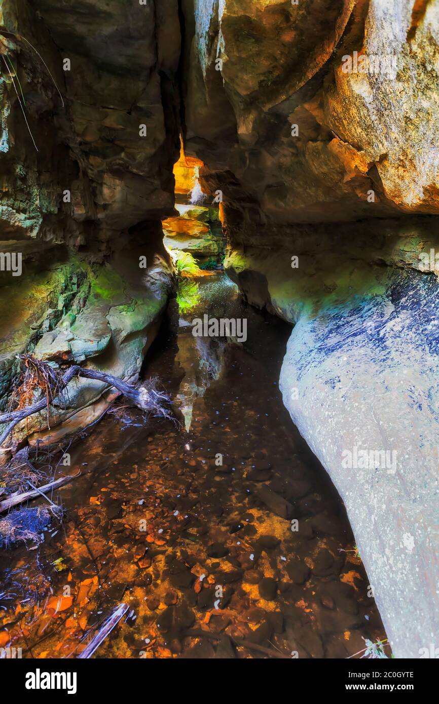 Dark cave eroded in sandstone rocks by running water in Grand Canyon of ...