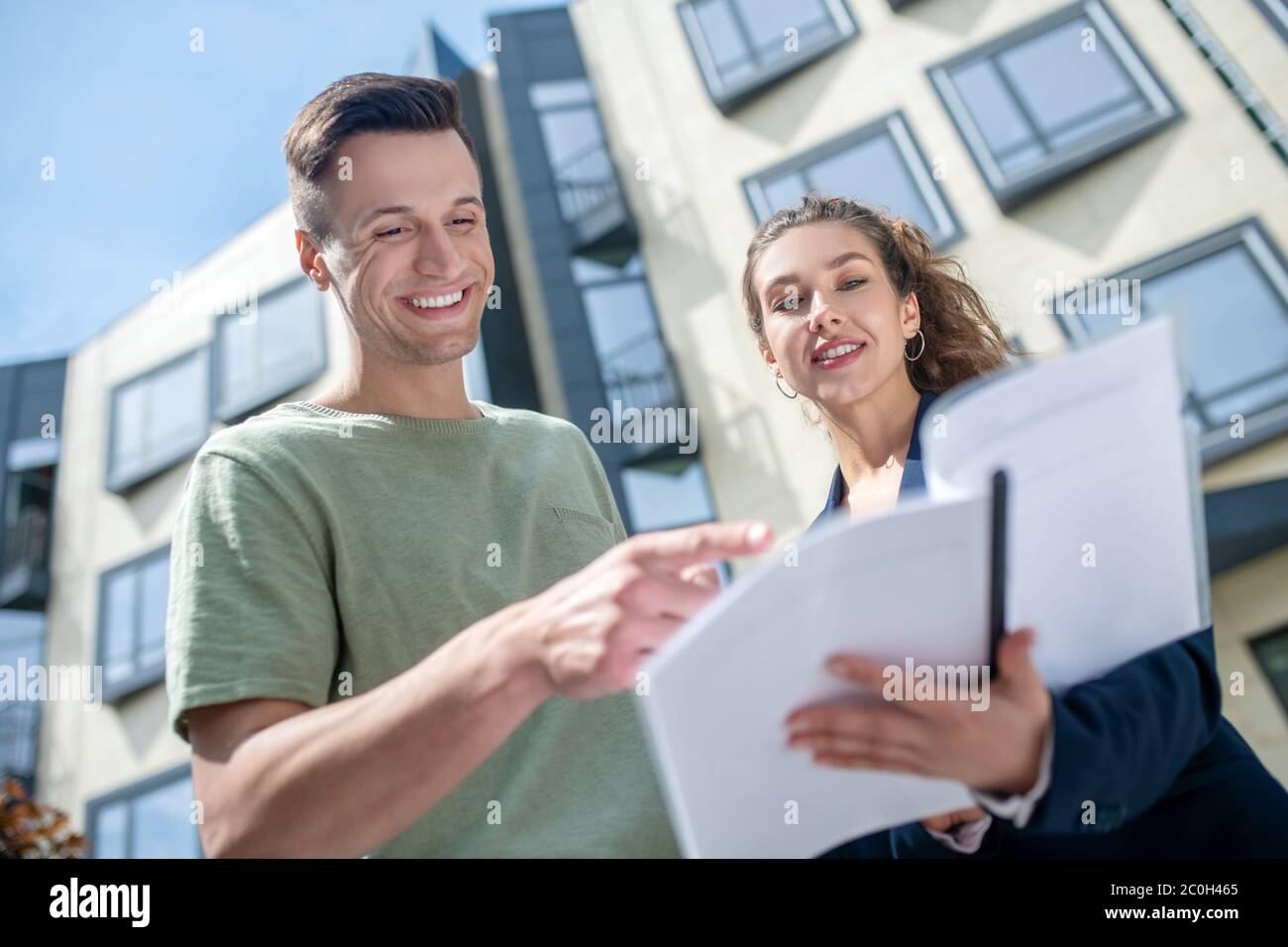 Elegant businesswoman showing the agreement to her client Stock Photo ...