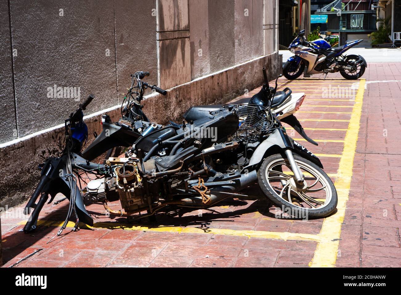 Disassembled by vandals abandoned bike in a parking lot Stock Photo - Alamy