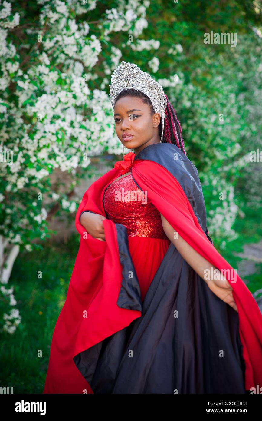 Queen in the crown and royal mantle. Lovely girl on the background of a ...