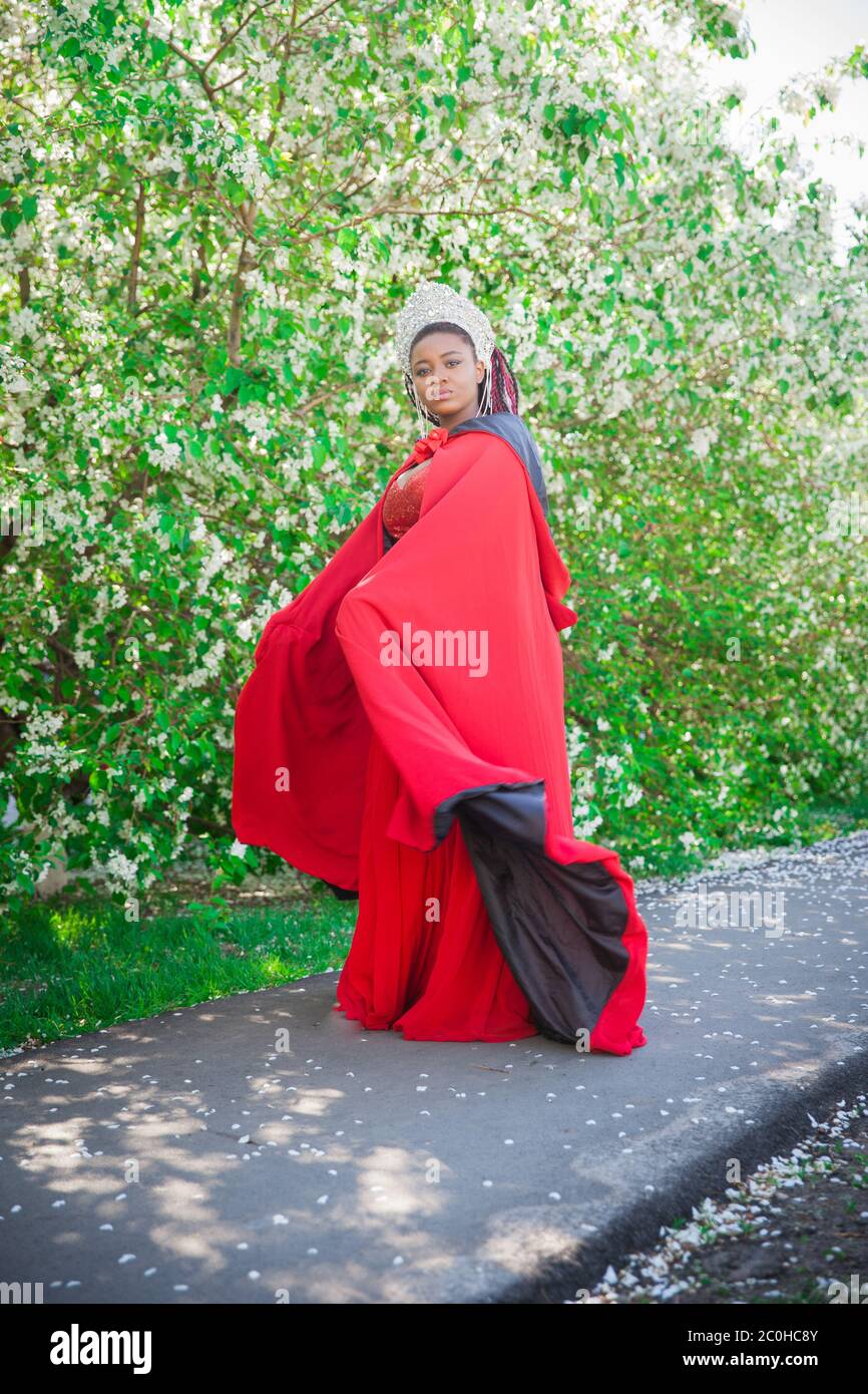 Queen in the crown and royal mantle. Lovely girl on the background of a ...