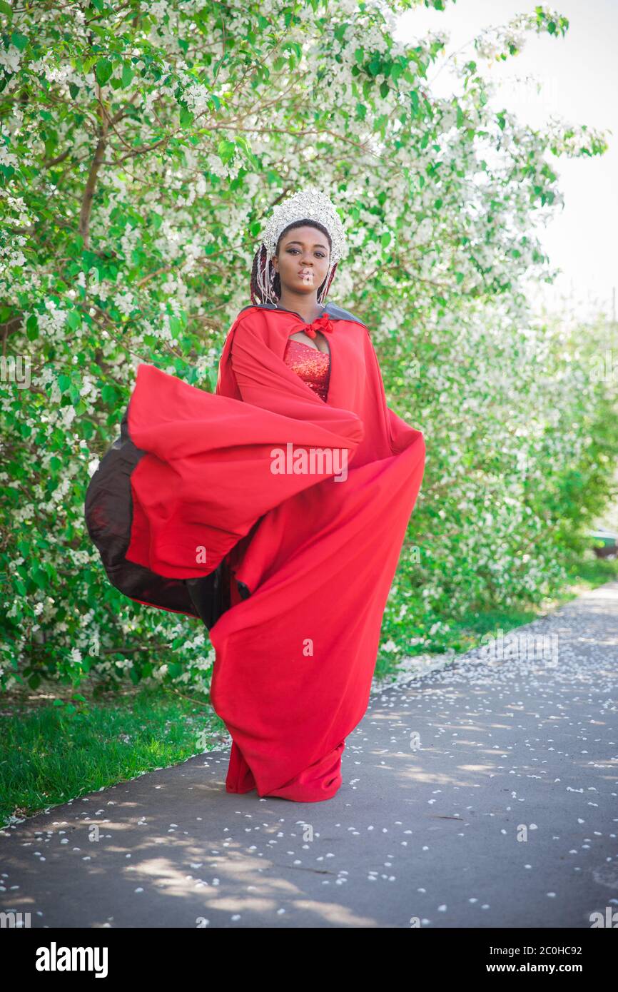 Queen in the crown and royal mantle. Lovely girl on the background of a ...