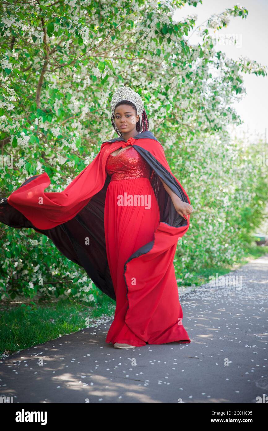 Queen in the crown and royal mantle. Lovely girl on the background of a ...