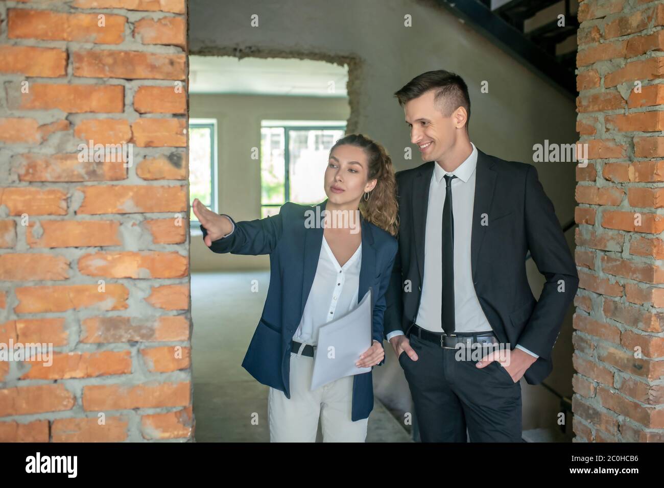 Female realtor showing new house for the customer Stock Photo - Alamy