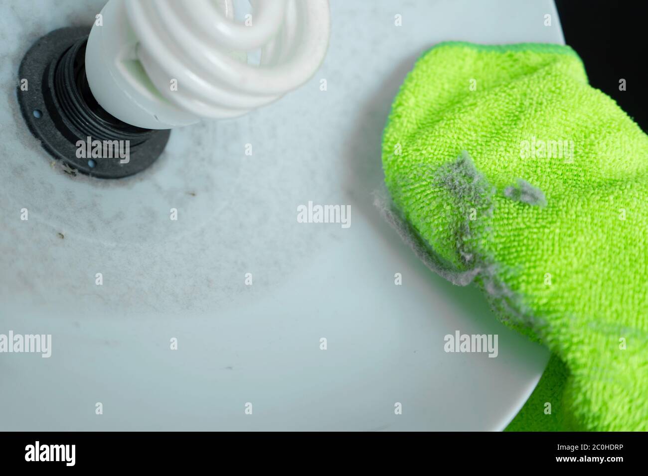 Cleaning the house. Wipe off the dust with a green rag from the floor ...