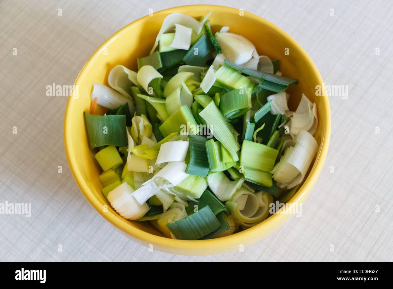 Thinly sliced leek in a bowl before cooking Stock Photo - Alamy